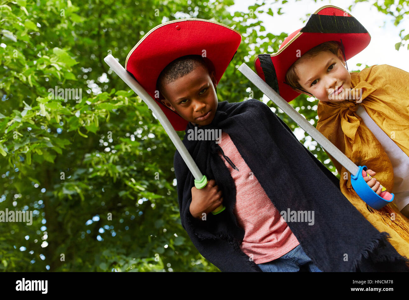 Two young kids dressed up like knights playing as friends Stock Photo ...