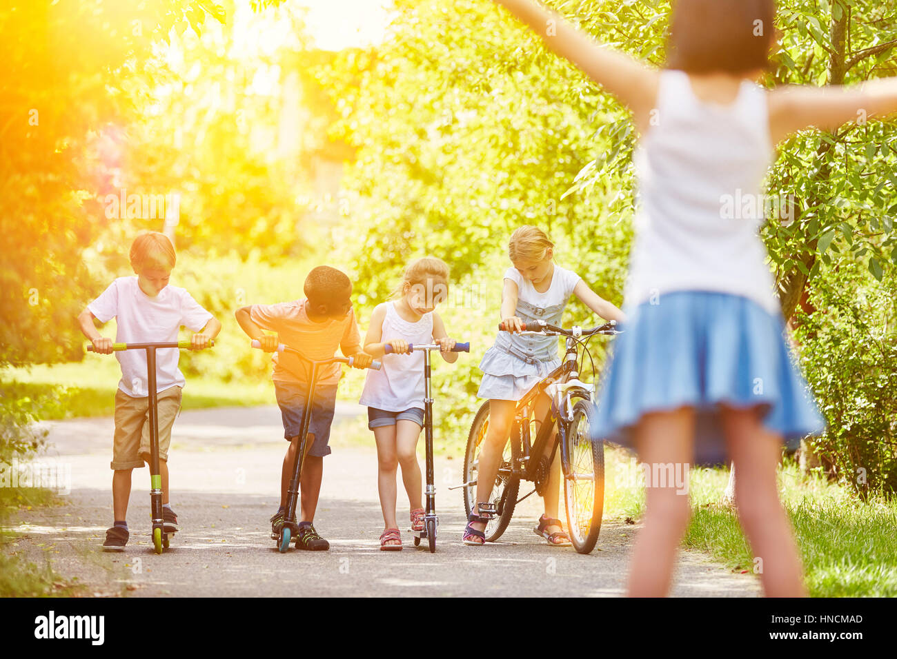 Children at race in the park with bicycle and scooters Stock Photo - Alamy