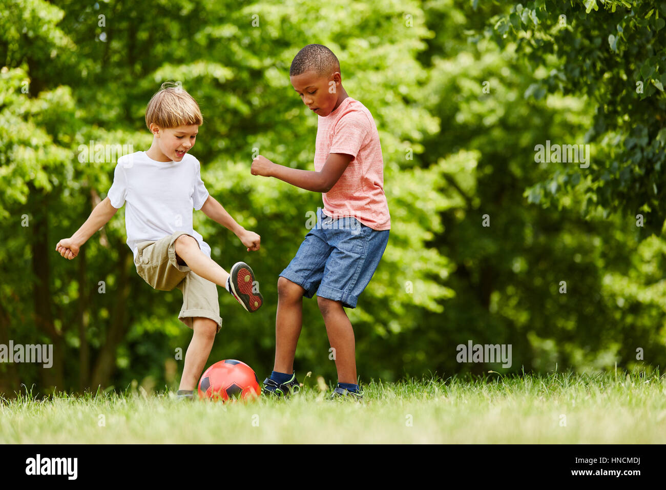 Two friends playing football hi-res stock photography and images - Alamy