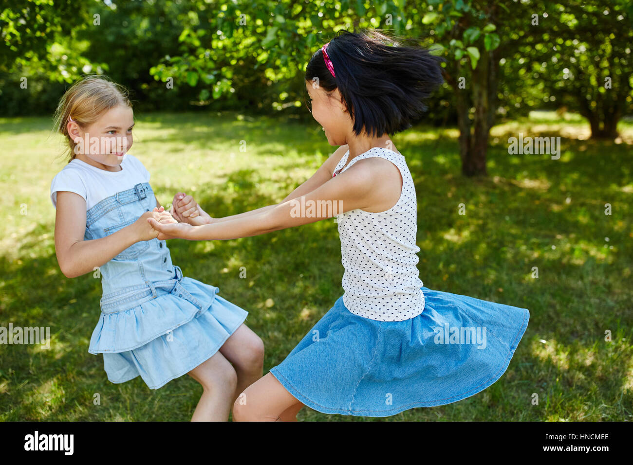 Girls play rotate two hi-res stock photography and images - Alamy