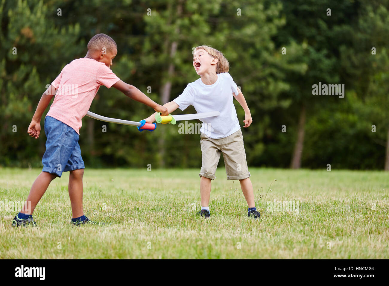 Kids play fighting sword fighting hi-res stock photography and images ...