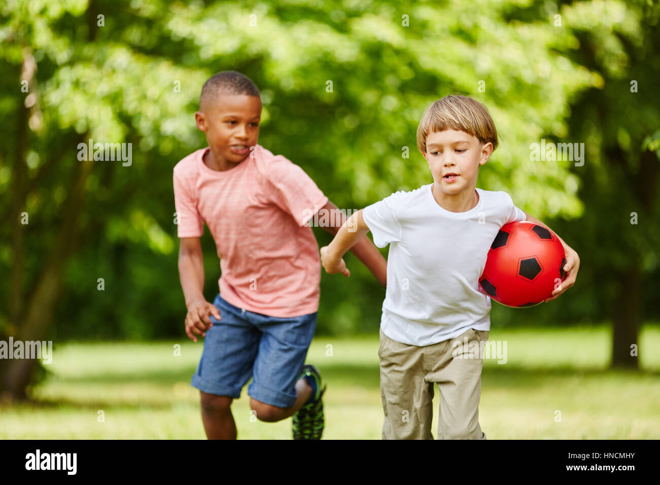 Children racing in the park during soccer match Stock Photo - Alamy