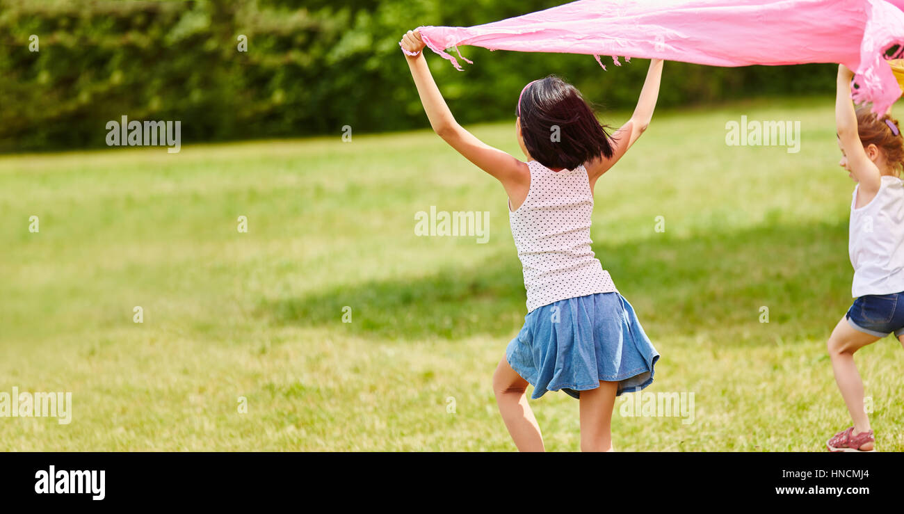 Children running with cloth in the air in summer Stock Photo - Alamy