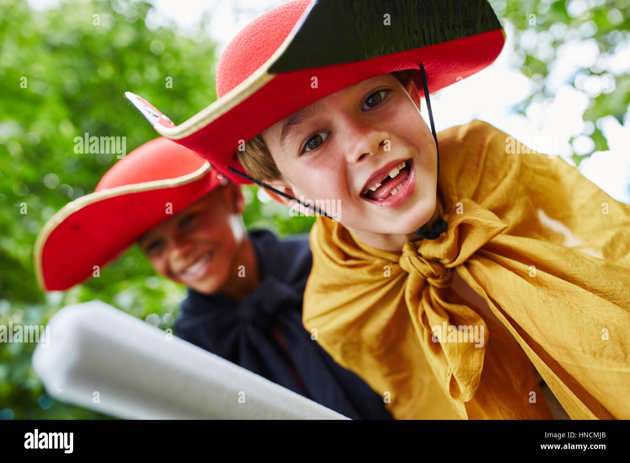 Two children in carnival dressed up like knights having fun together ...