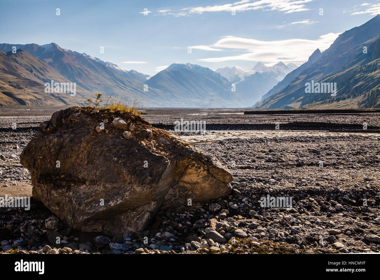 Big stone near river in the morning Stock Photo - Alamy