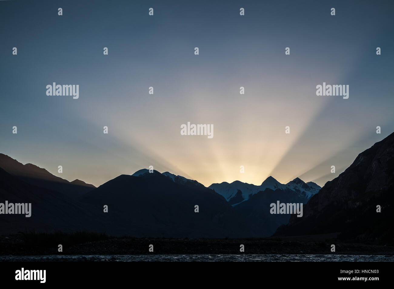 Beautiful sunrise in the morning clear sky with rays and mountain ...