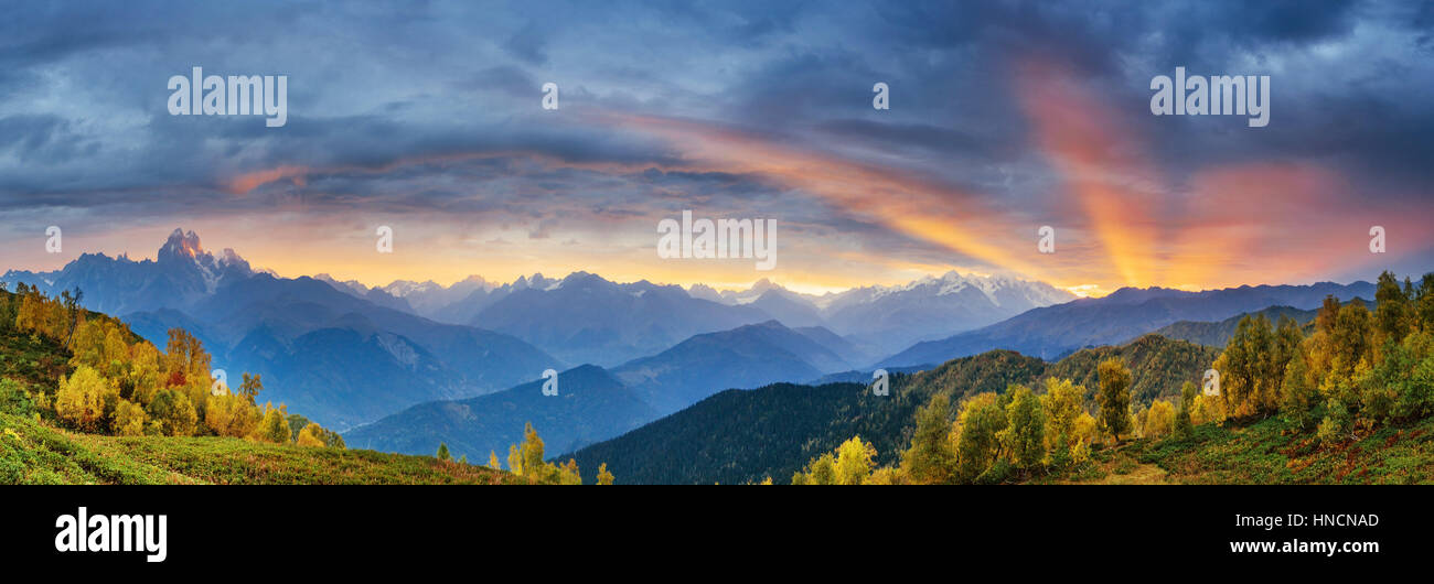 Sunset over snow-capped mountain peaks. The view from the mounta Stock ...