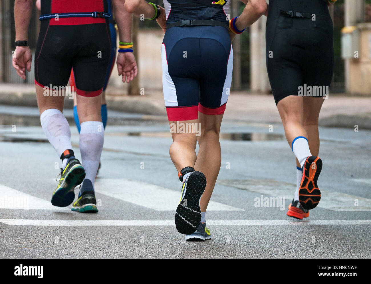 Group of marathon runners on the street. Back view Stock Photo - Alamy