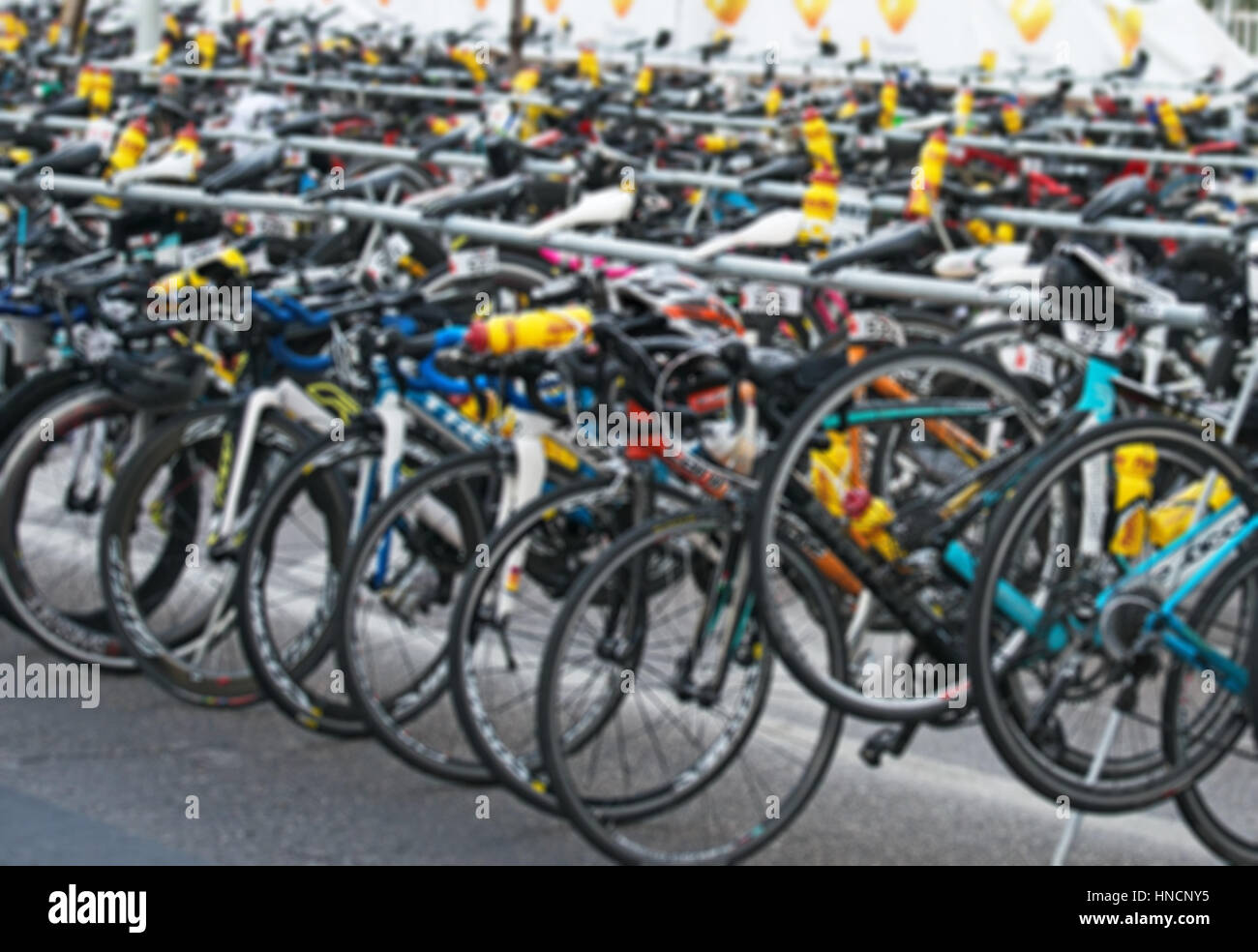 Many bicycles after race on the street. Blurred image Stock Photo - Alamy