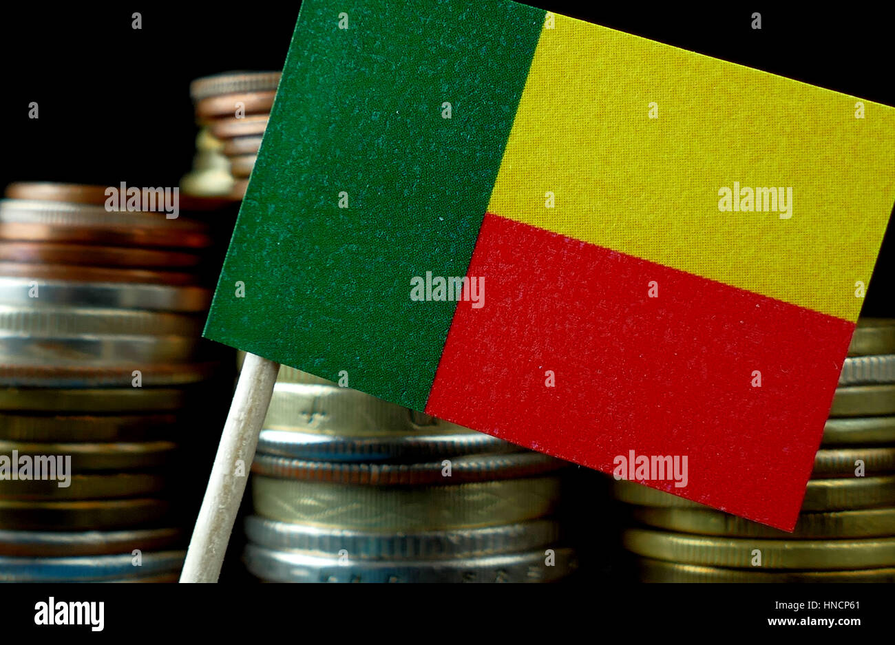 Benin flag waving with stack of money coins macro Stock Photo - Alamy
