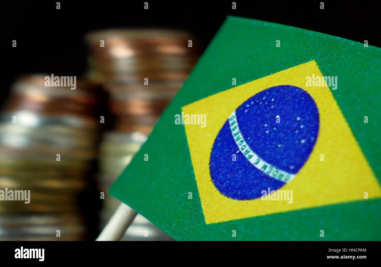 Brazilian flag waving with stack of money coins macro Stock Photo - Alamy