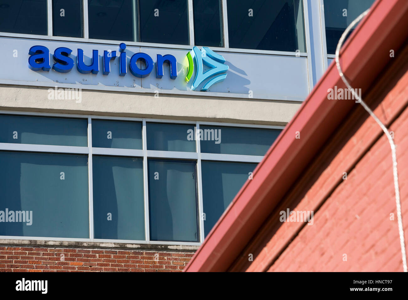 A logo sign outside of a facility occupied by Asurion in Nashville ...