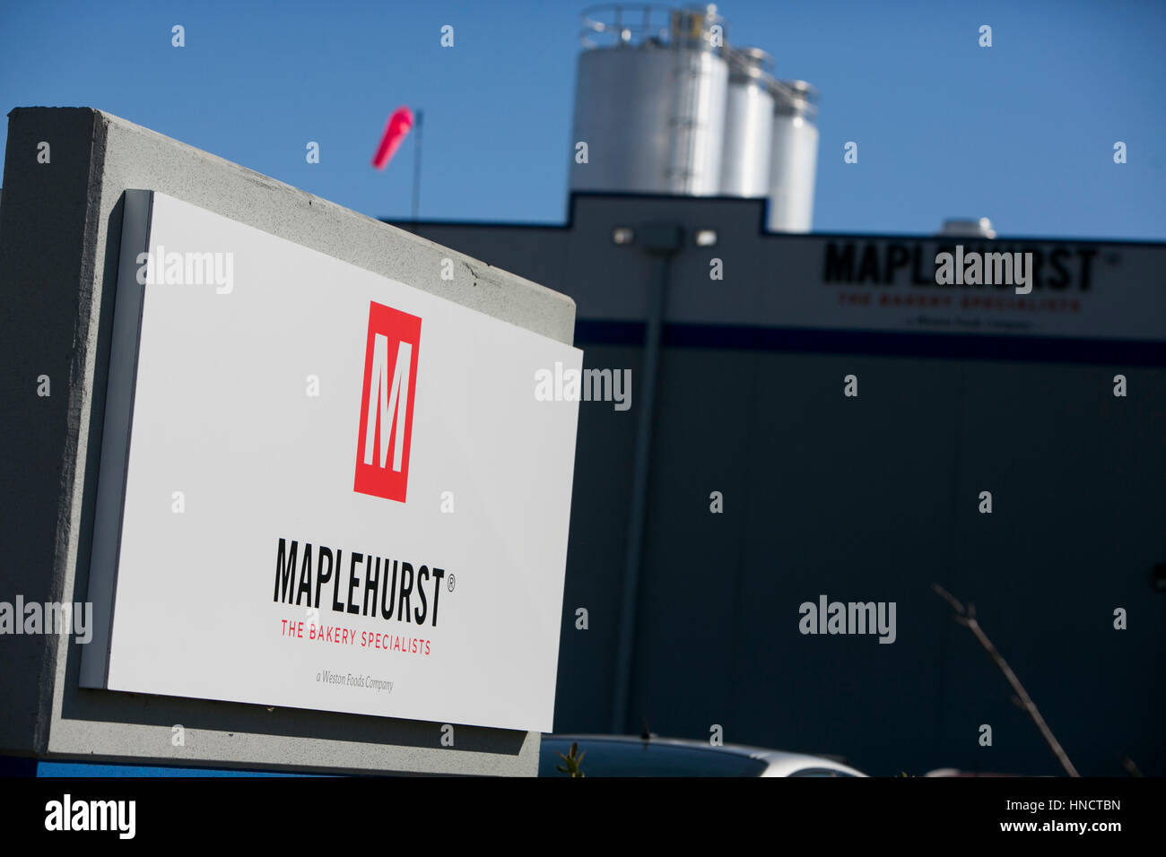 A logo sign outside of a facility occupied by Maplehurst Bakeries in ...