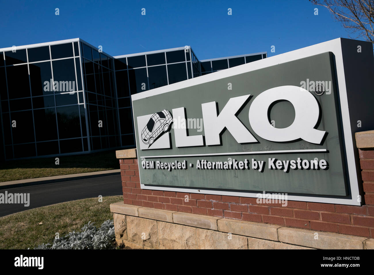 A logo sign outside of a facility occupied by the LKQ Corporation in ...