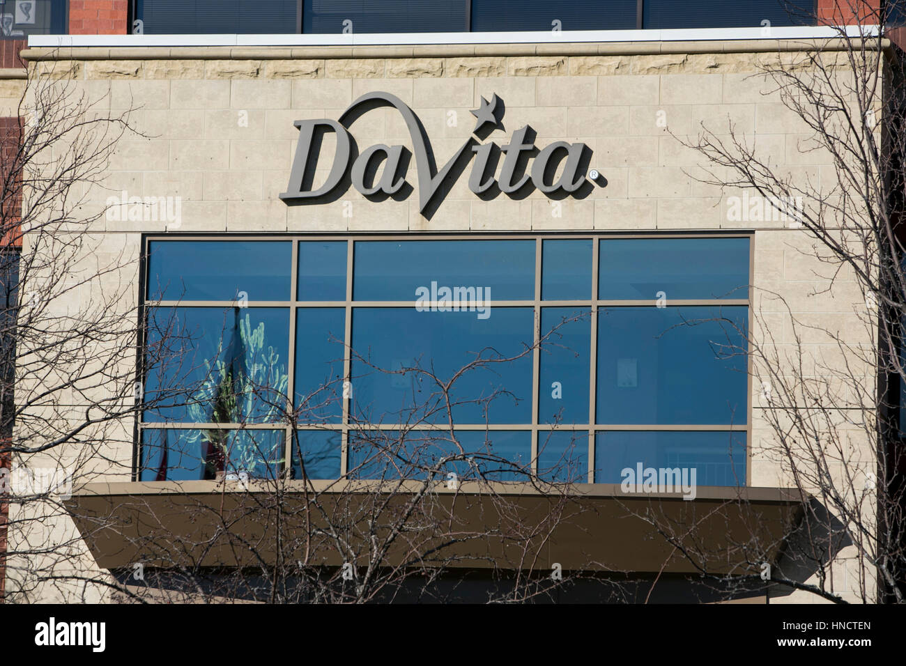 A logo sign outside of a facility occupied by DaVita, Inc., in ...