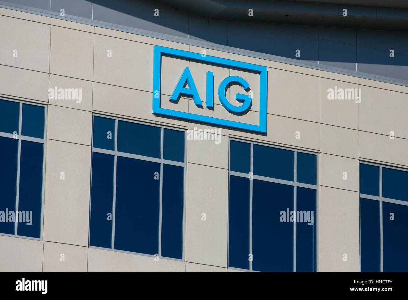 A logo sign outside of a facility occupied by American International ...