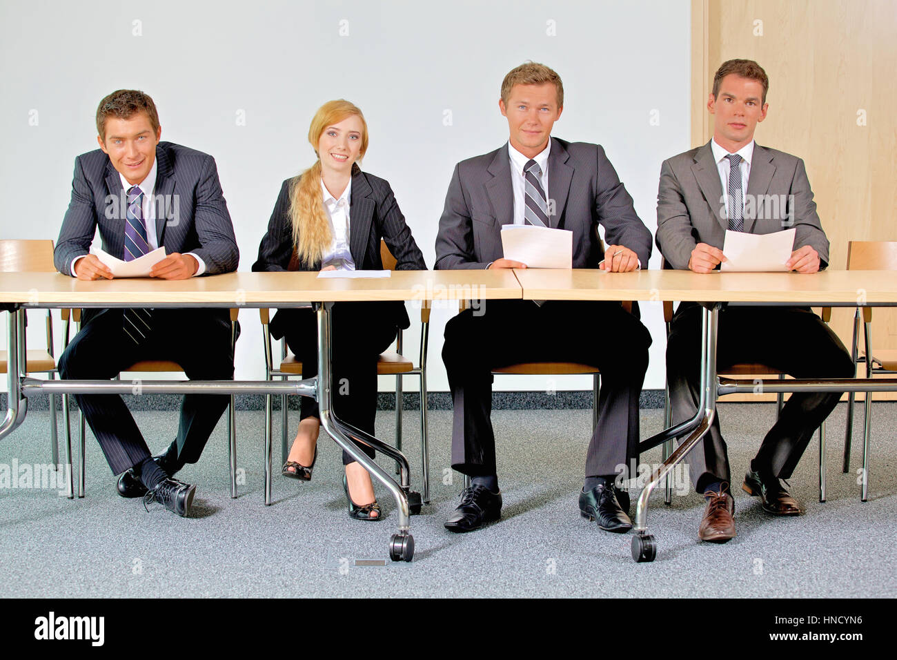 Portrait of business people sitting in office Stock Photo - Alamy