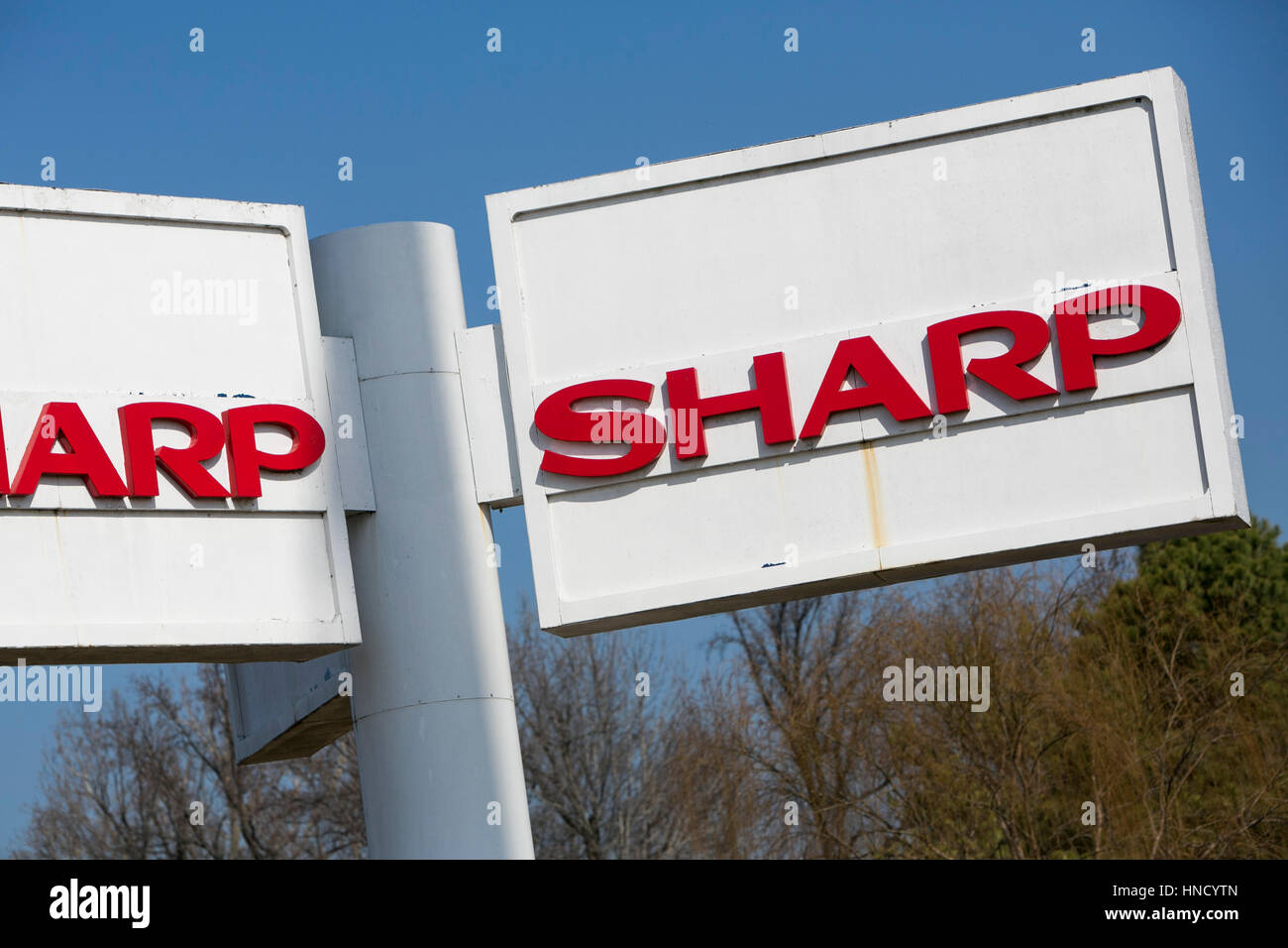 A logo sign outside of a facility occupied by the Sharp Corporation in ...