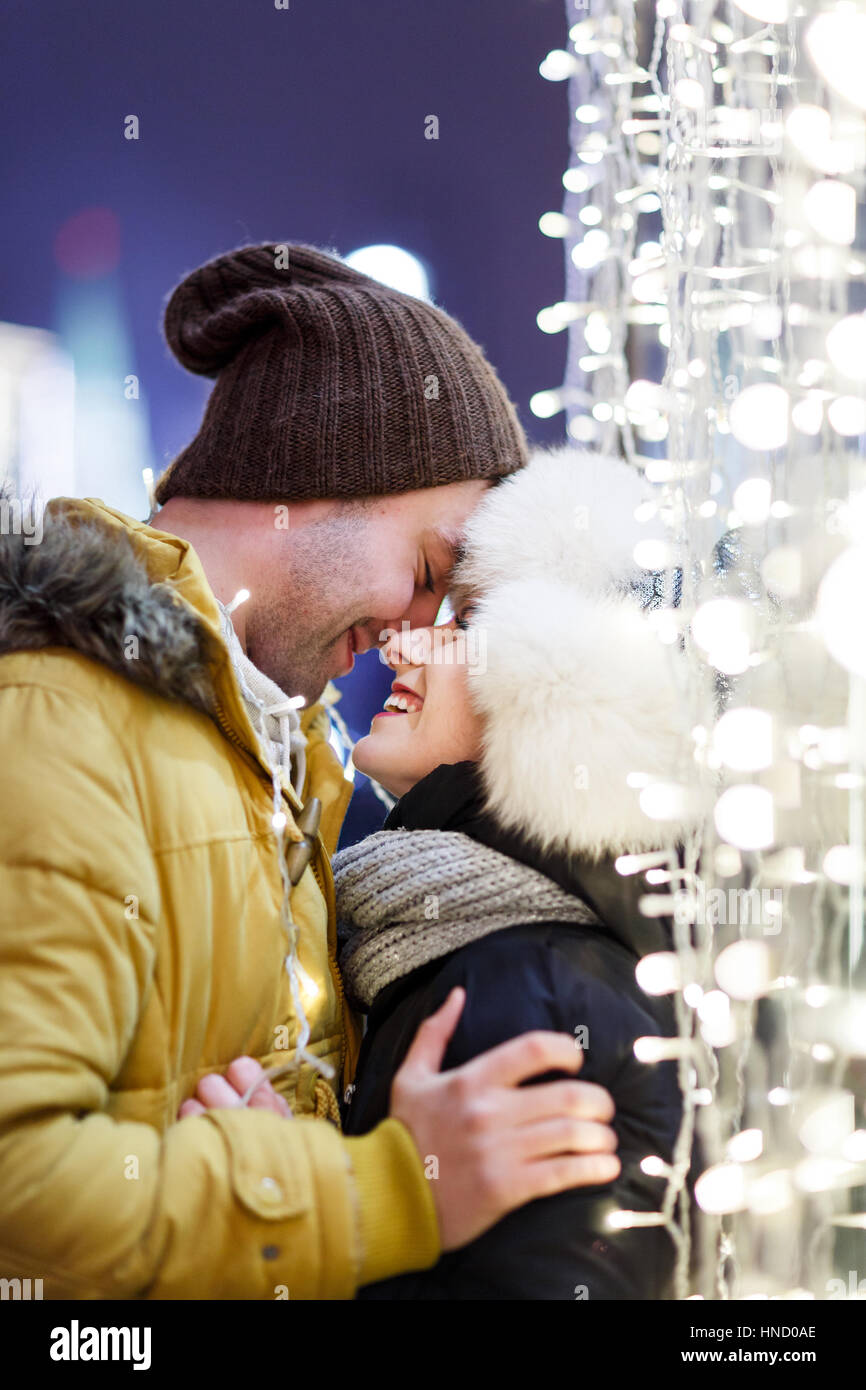 Loving couple cuddling on street in winter night Stock Photo - Alamy