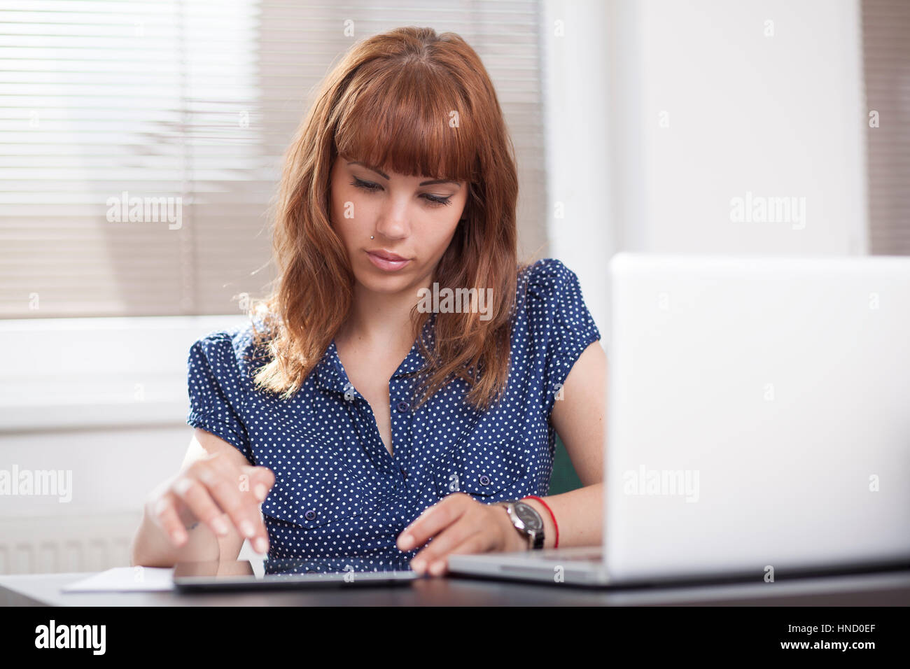 Brunette girl with long hair working on her desk with laptop Stock ...
