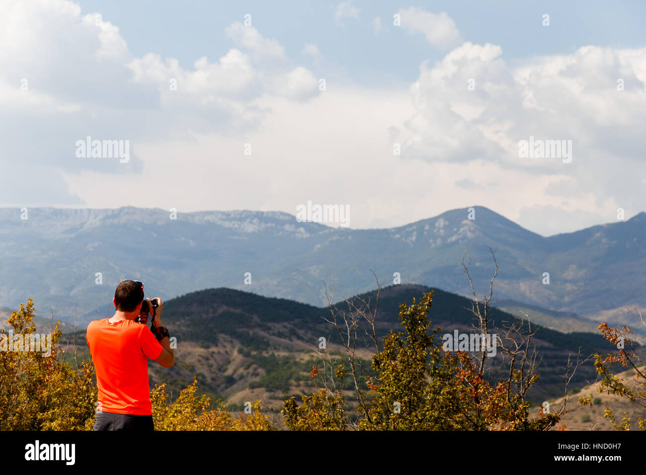 Man photographing scenic mountain landscape in day Stock Photo - Alamy