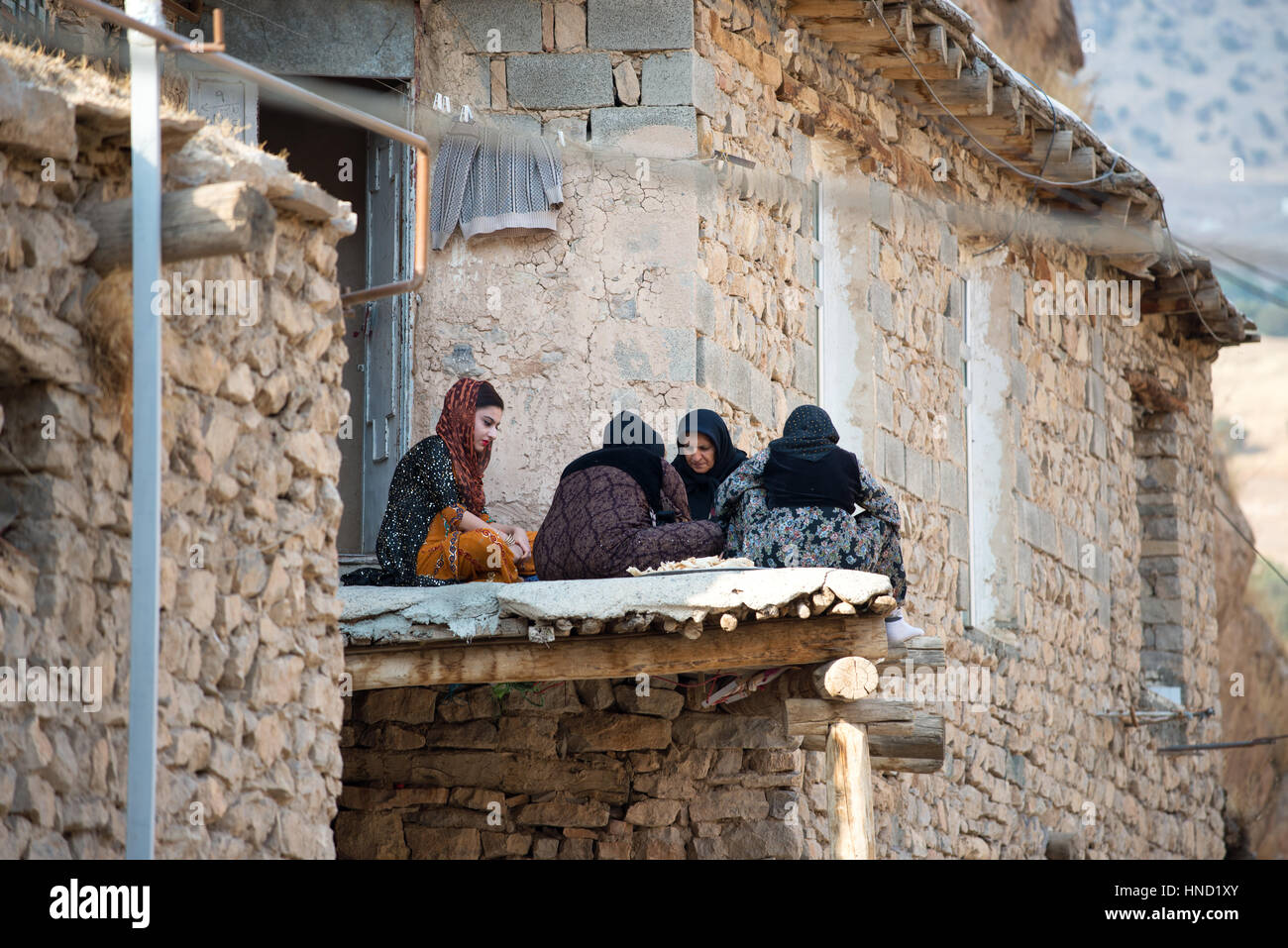 A group of kurdish women chatting seated, Palangan ancient village, Iranian Kurdistan, Iran ...