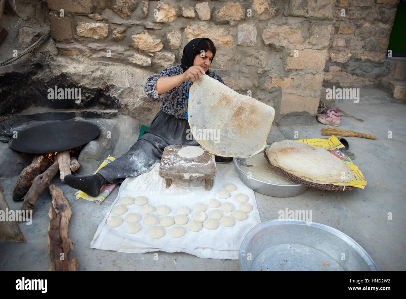 A kurdish woman preparing traditional bread, Palangan ancient village ...
