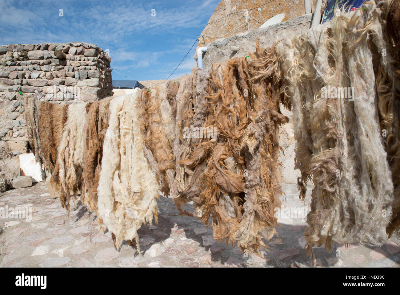 Fleeces drying among traditional cliff dwellings of ancient village of ...