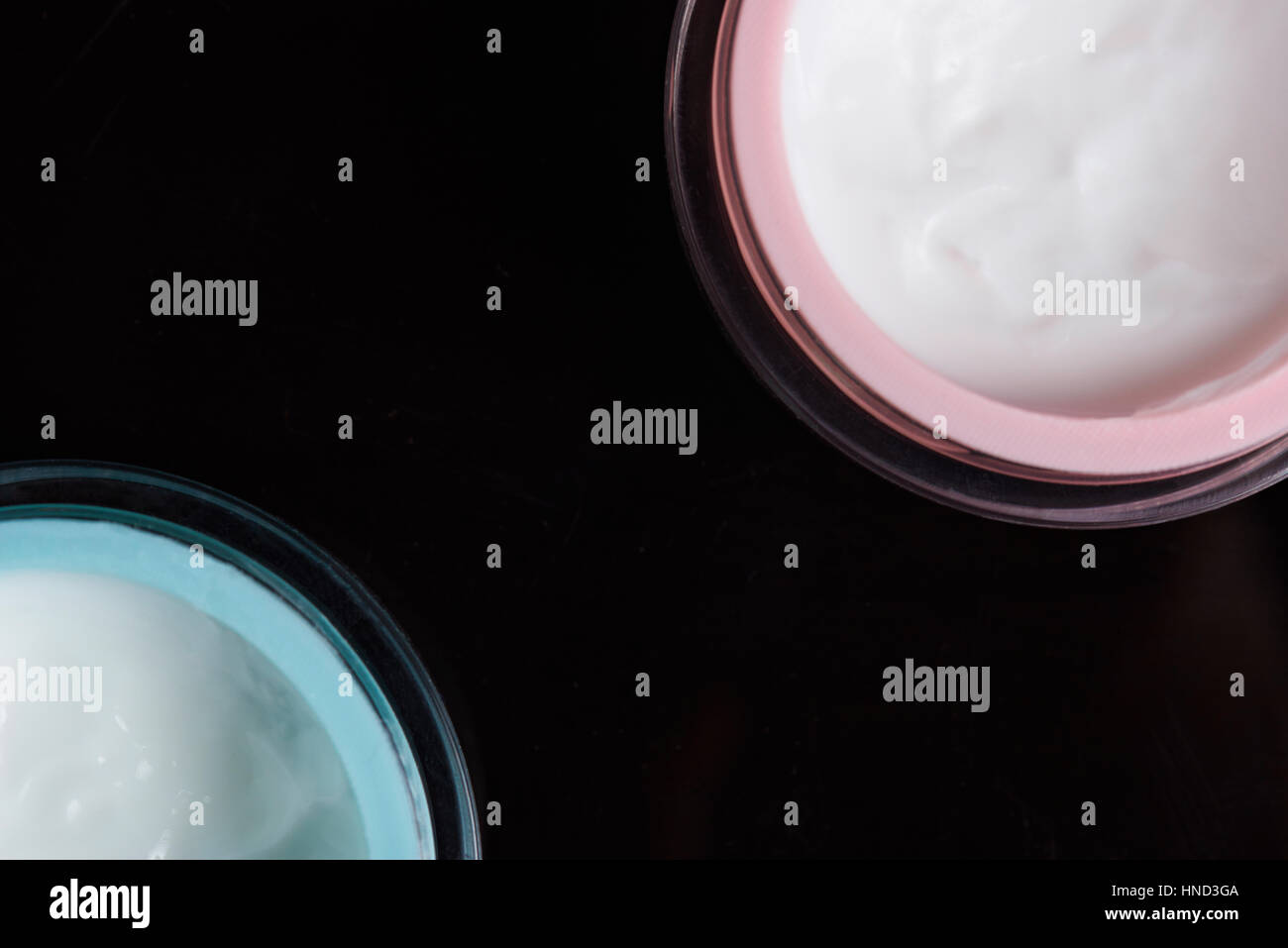 Two container with cosmetic face cream. Cream bottles close up with ...