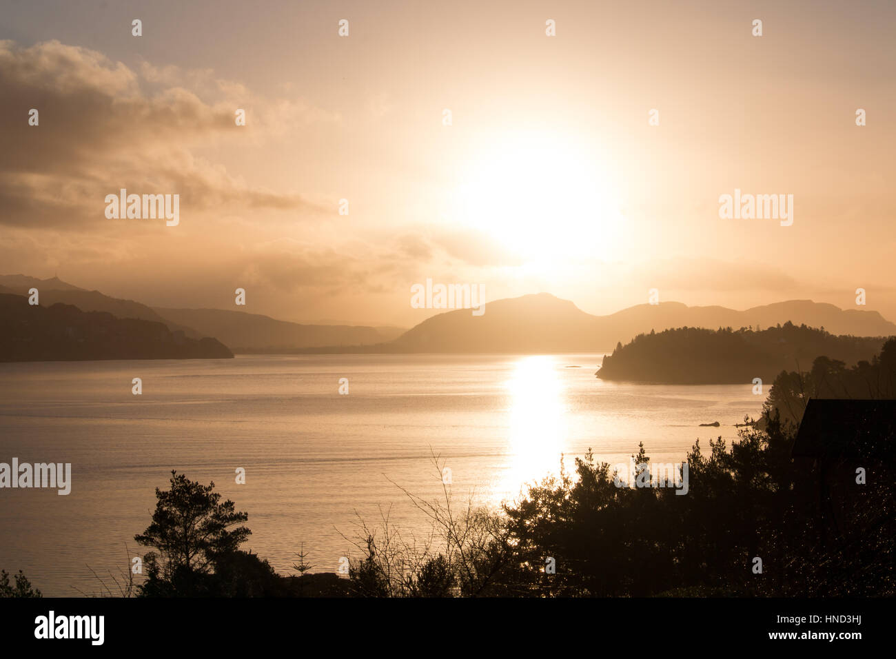 Norway fjord of Bergen at sunrise with golden light forest and ...