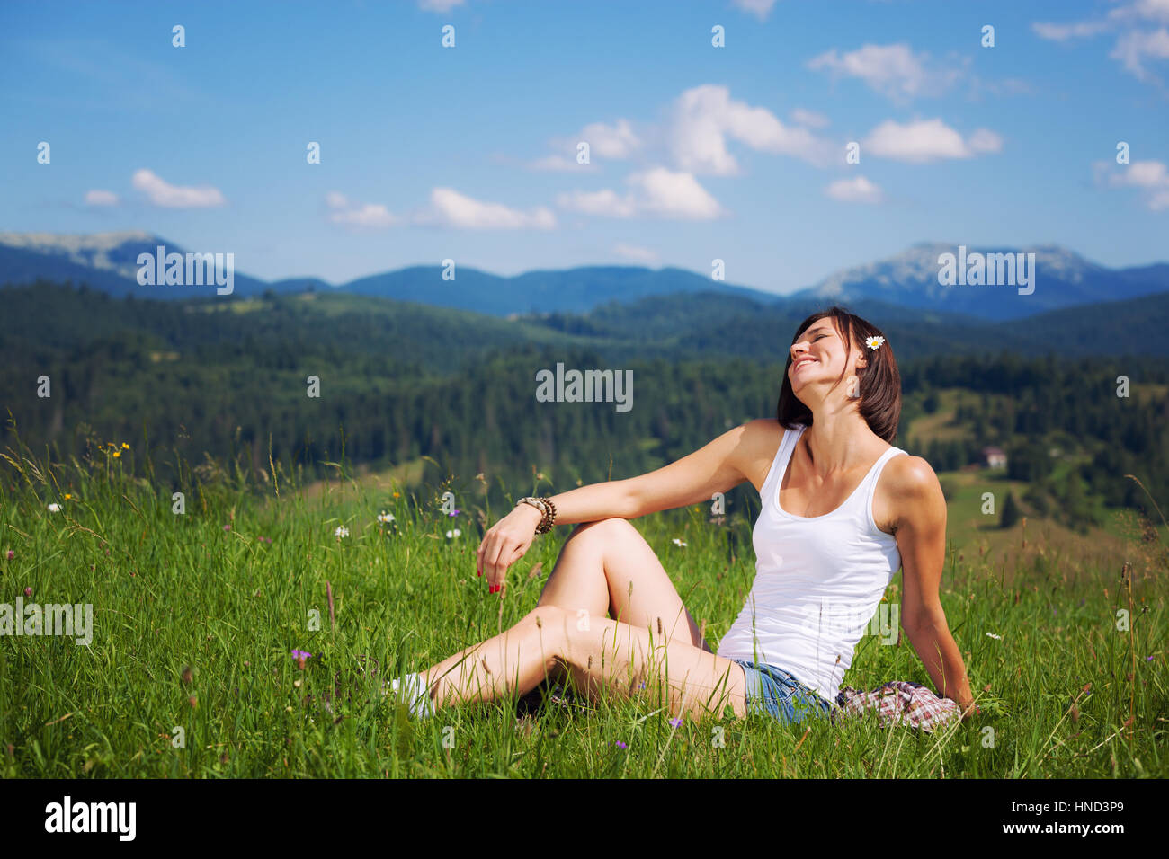 Beautiful girl lying on green grass field Stock Photo - Alamy