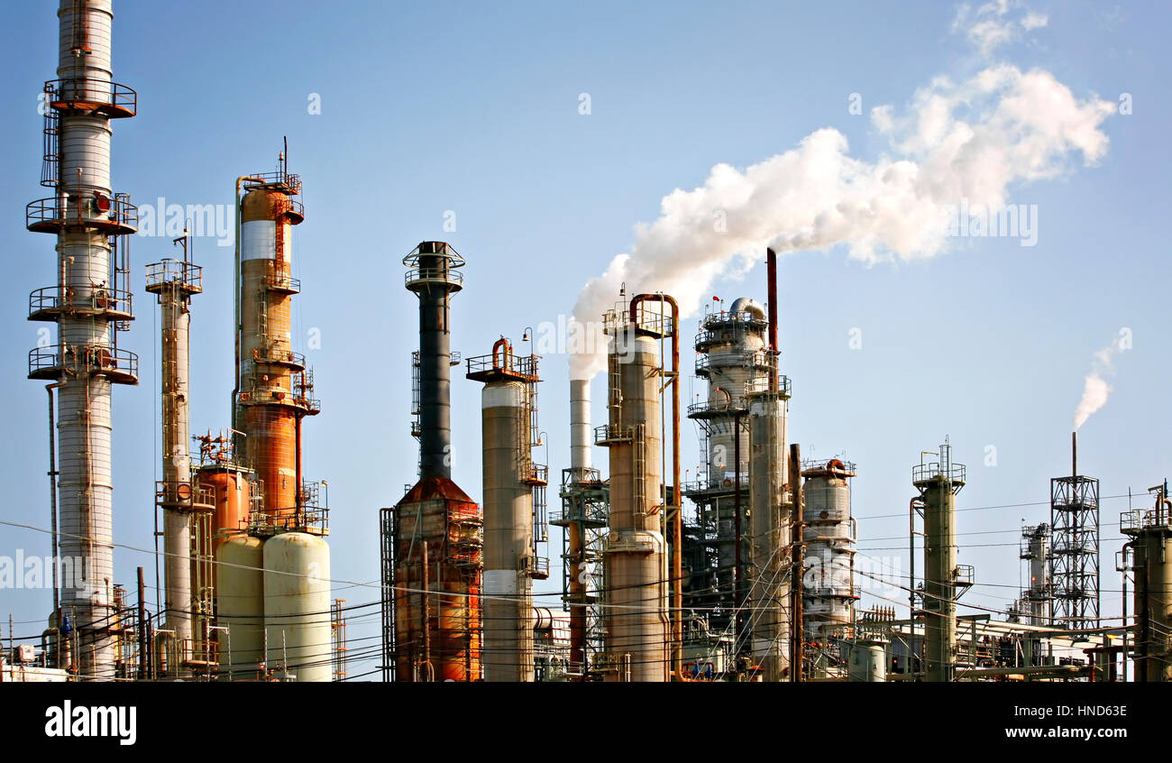 Working refinery plant, oil industry with smoke on blue sky background ...