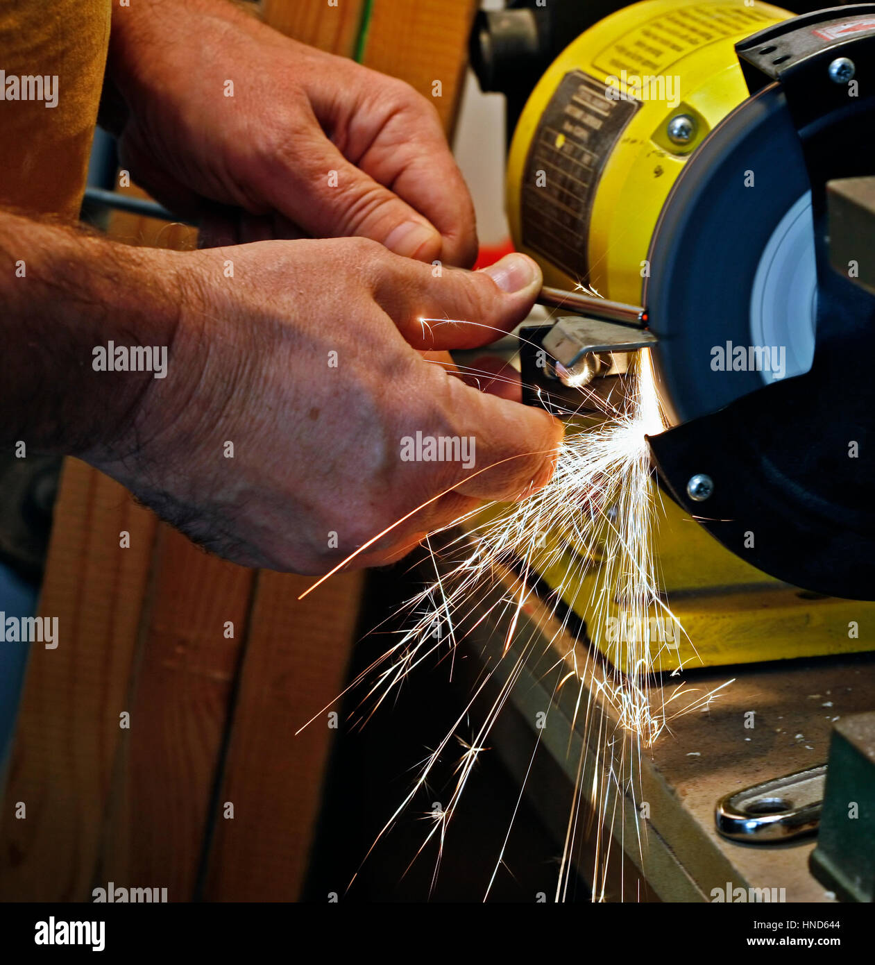 Worker's hand sharpening the tool at the workshop ** Note: Shallow ...