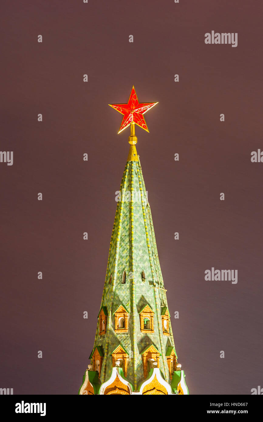 Moscow Kremlin in winter night. The spire of Borovitskaya tower with ...