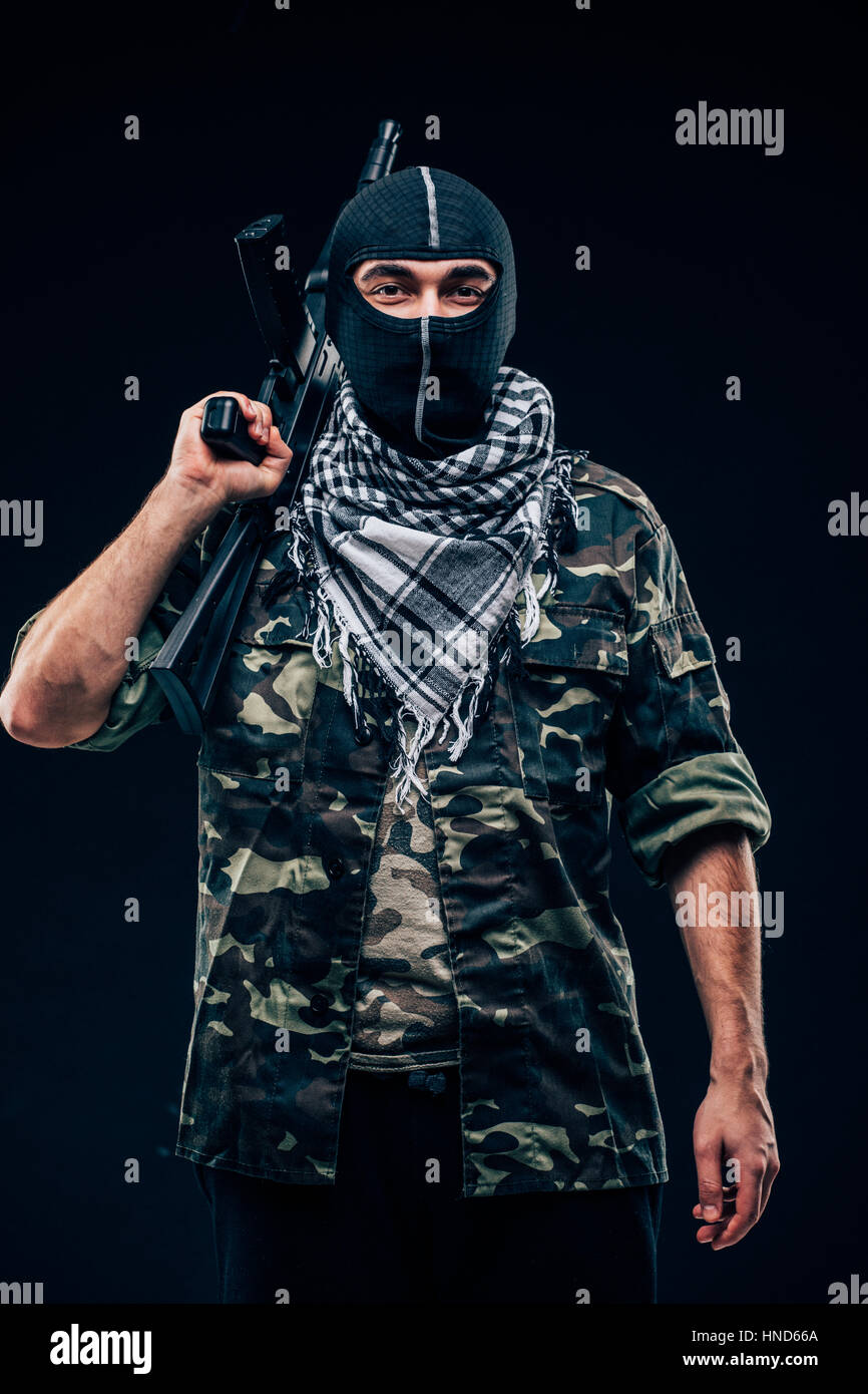 Terrorist attack. Terrorist with gun on black background Stock Photo ...