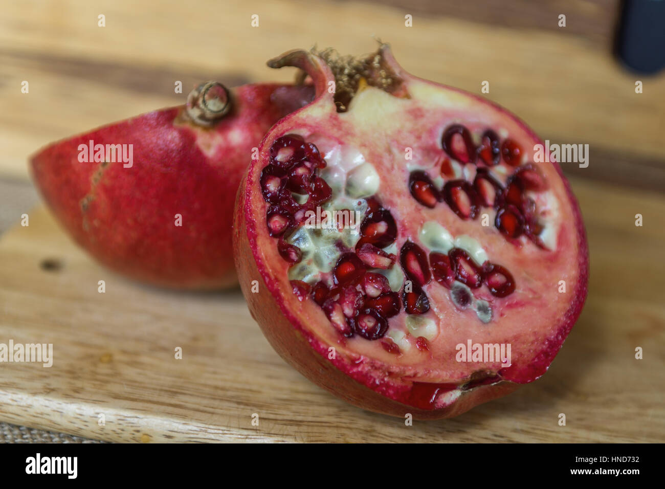 Ripe pomegranate fruit on wooden vintage background Stock Photo - Alamy