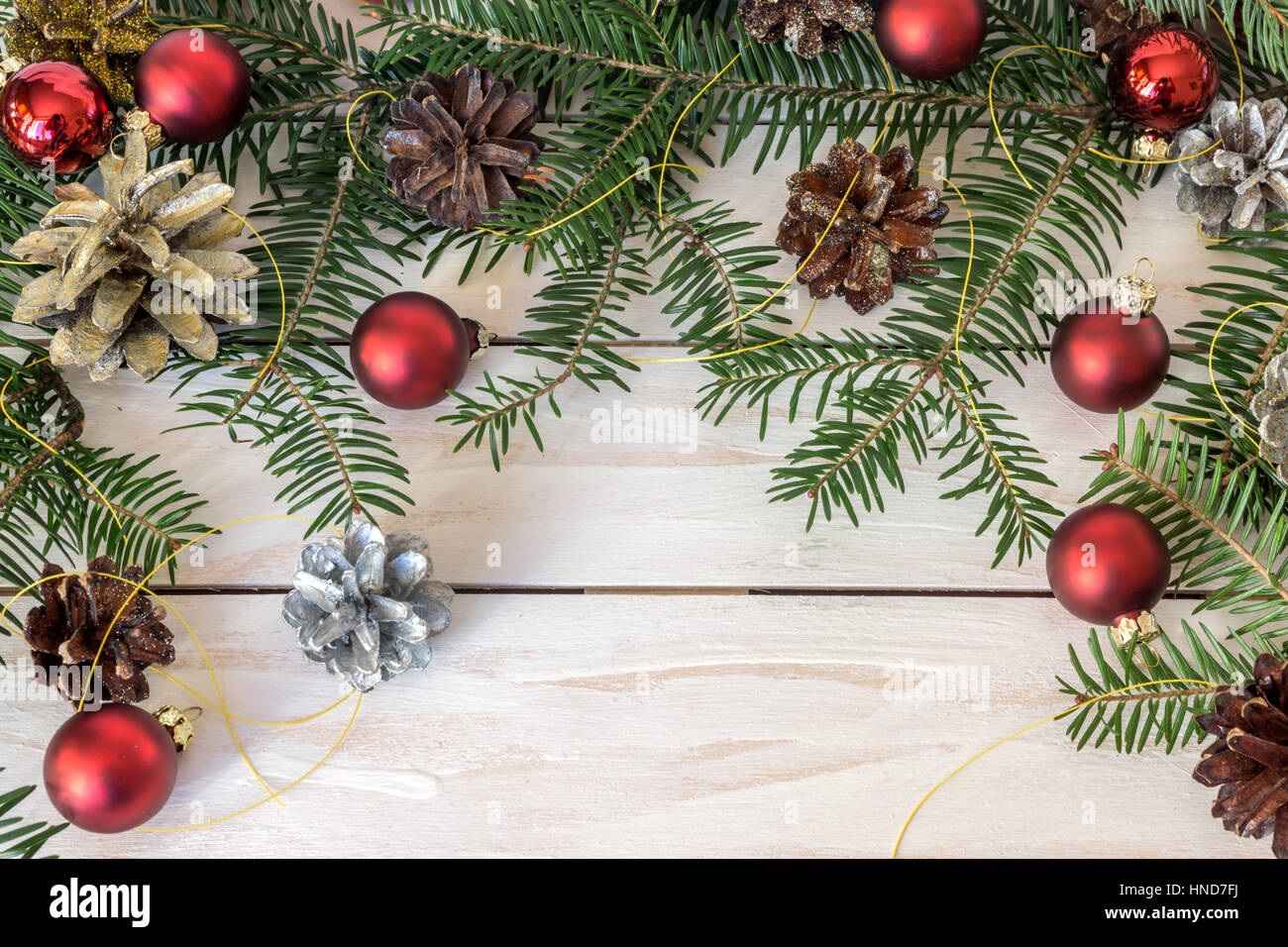 Christmas decoration with branches from fir cones and toys on white ...