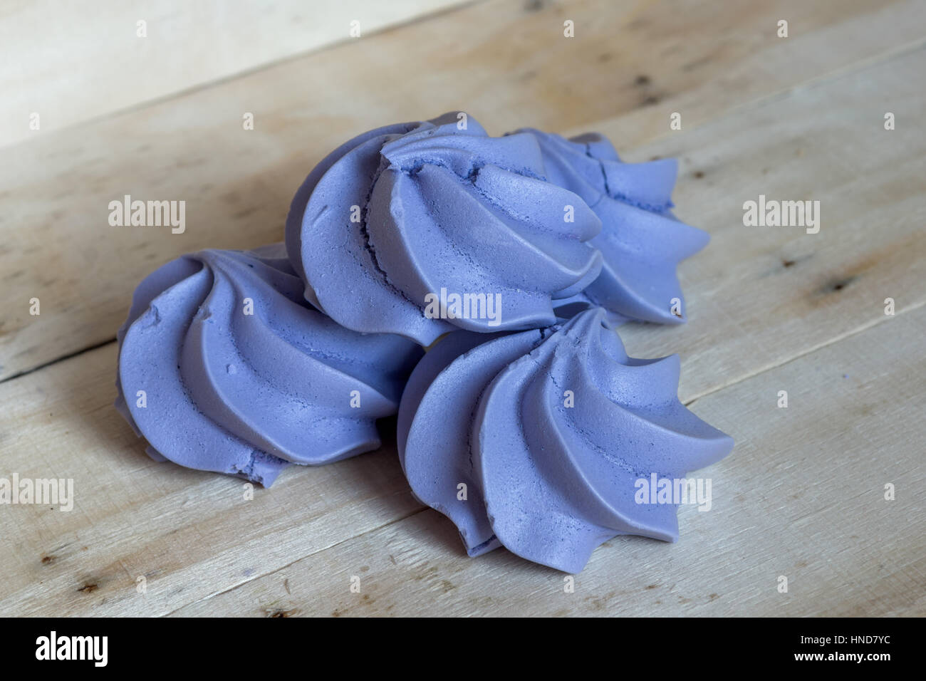 French blue meringue cookies on white wooden background Stock Photo - Alamy