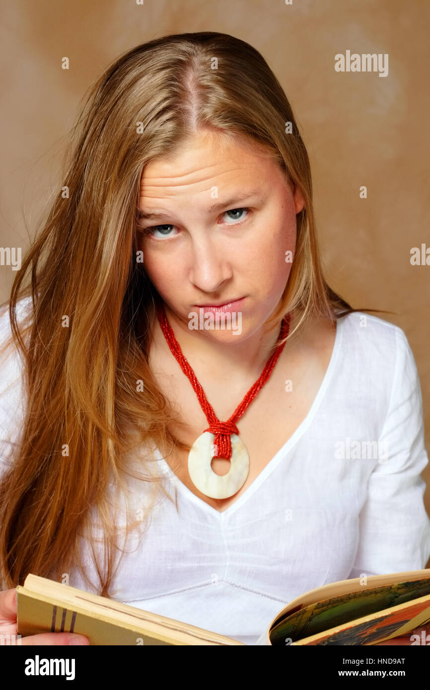 teen girl is carrying a stack of books Stock Photo - Alamy