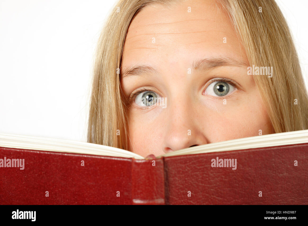 a teen girl looks over a book Stock Photo - Alamy