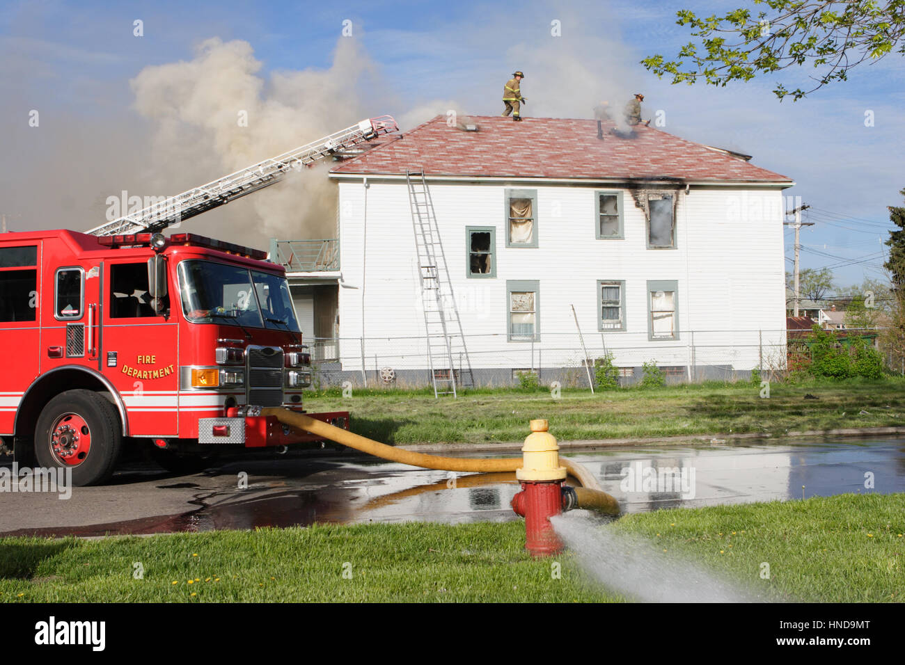 Firefighters putting out a house fire Stock Photo - Alamy