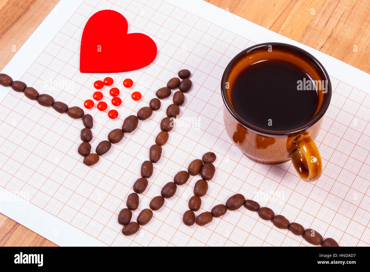Electrocardiogram line of roasted coffee grains, cup of hot coffee and ...