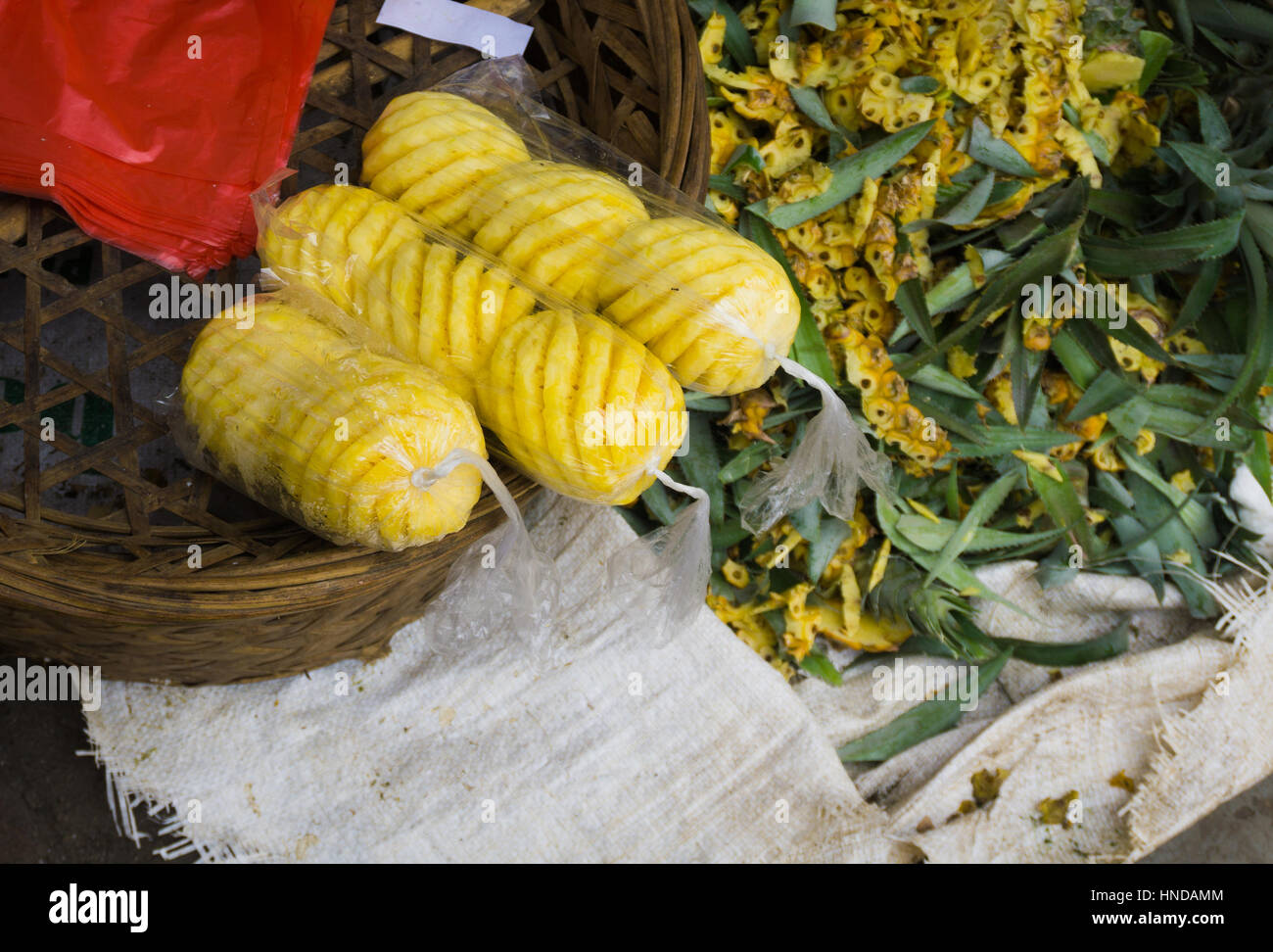 peeled pineapples already packed in plastic wrap sell in traditional ...