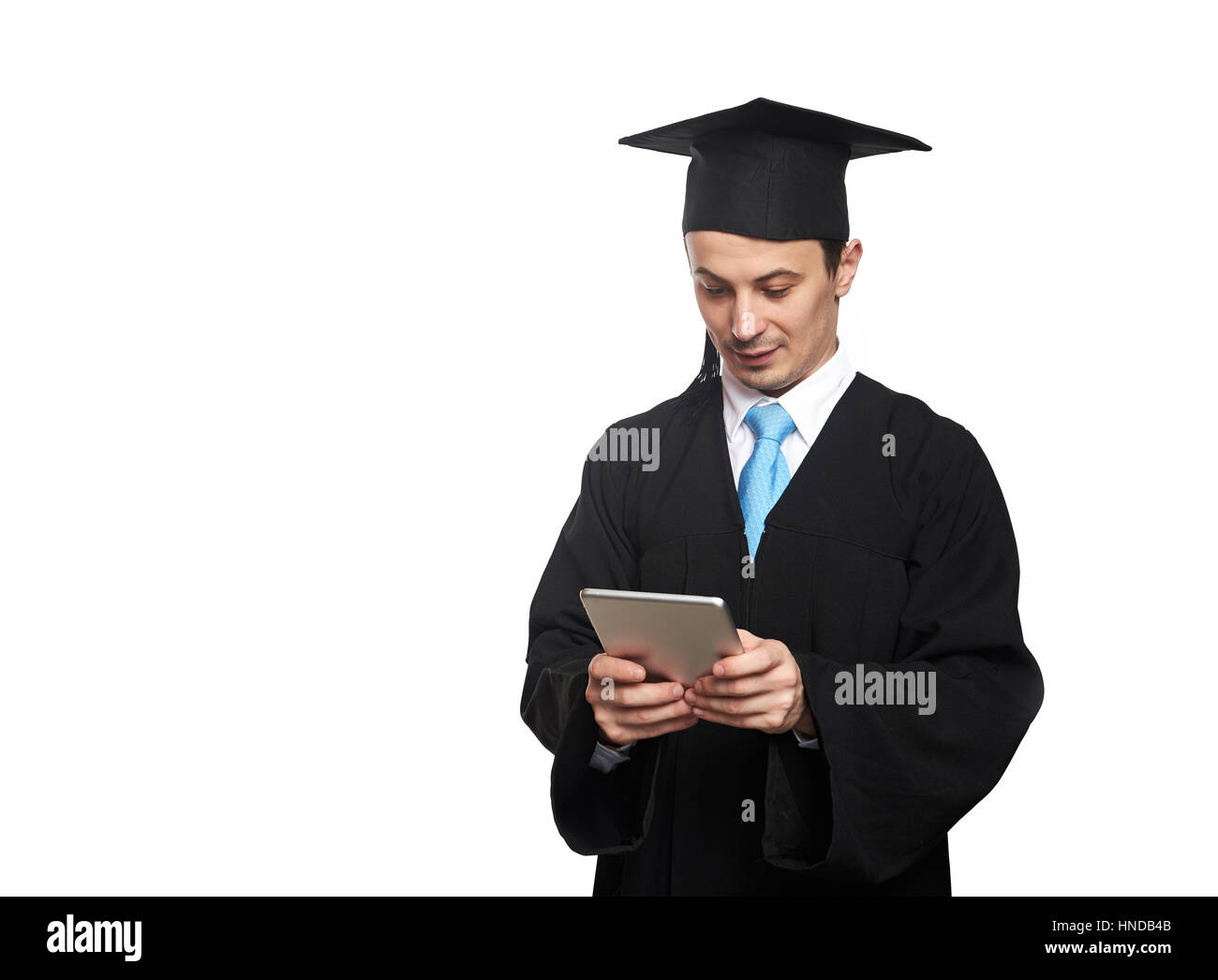 Graduating student with tablet isolated on white background Stock Photo ...