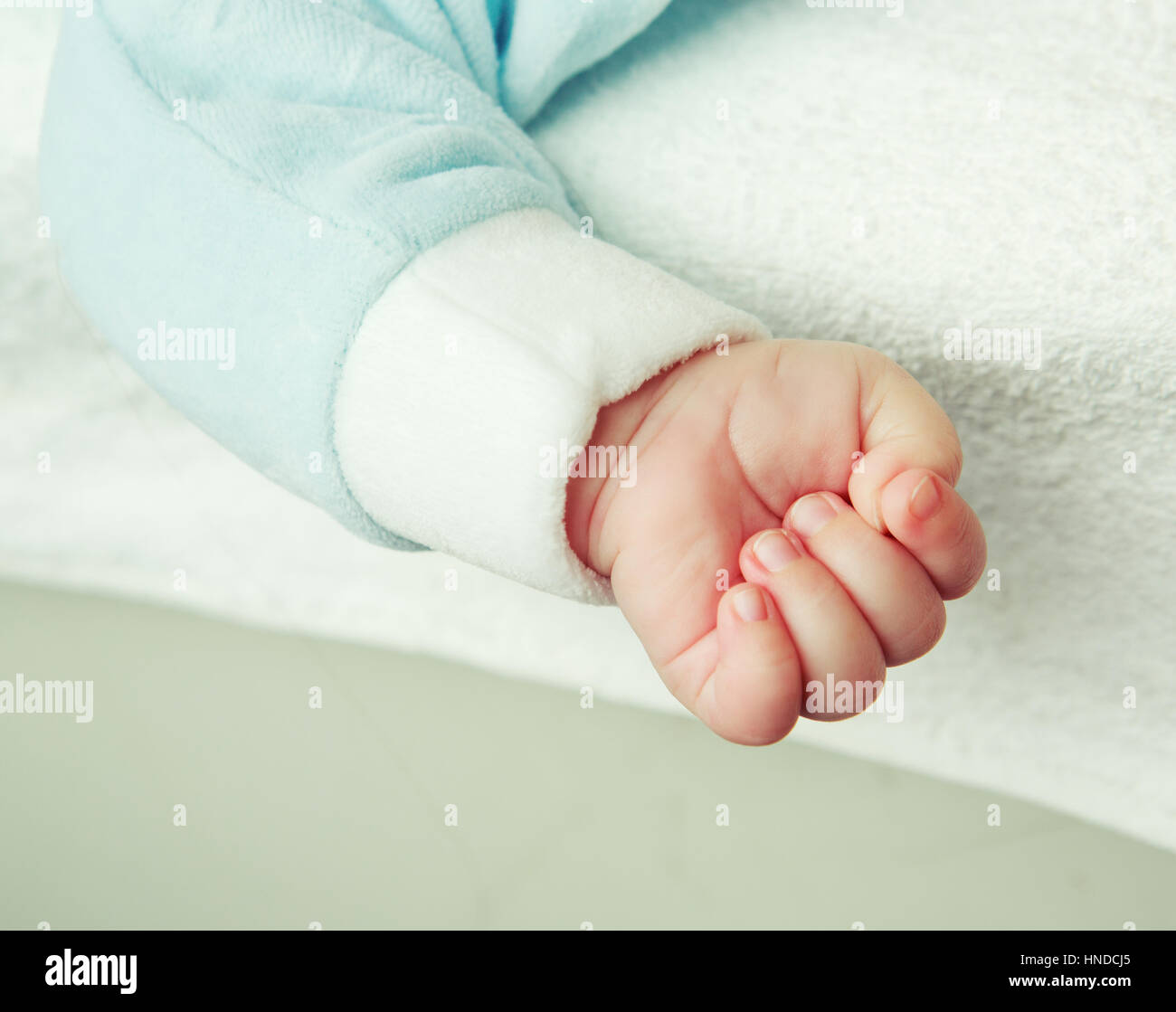 arm of a baby lying in bed at home Stock Photo - Alamy