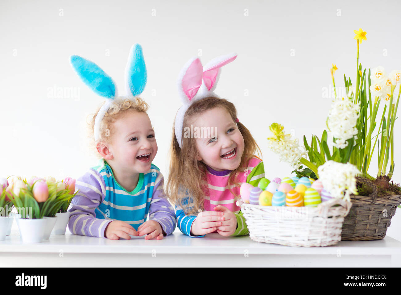 Happy children celebrate Easter at home. Boy and girl wearing bunny ...
