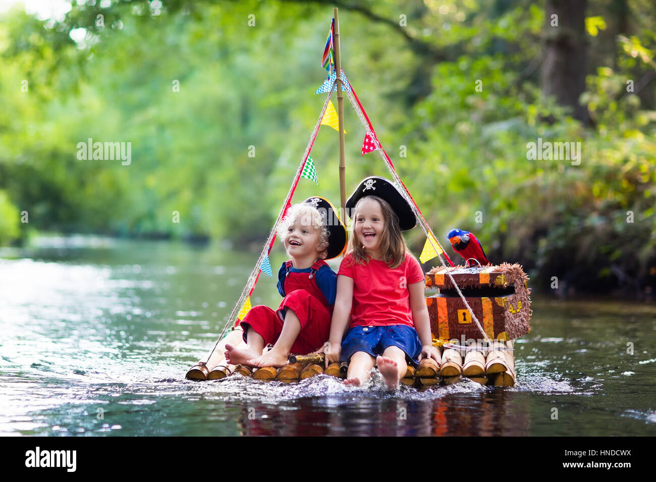 Kids dressed in pirate costumes and hats with treasure chest ...