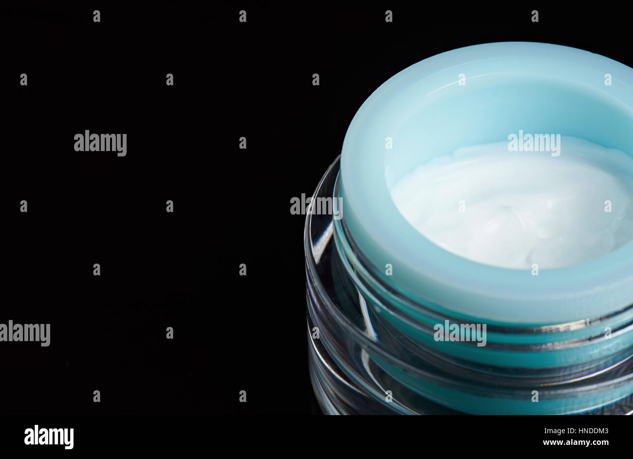 one blue white face cream container jar isolated on black background ...