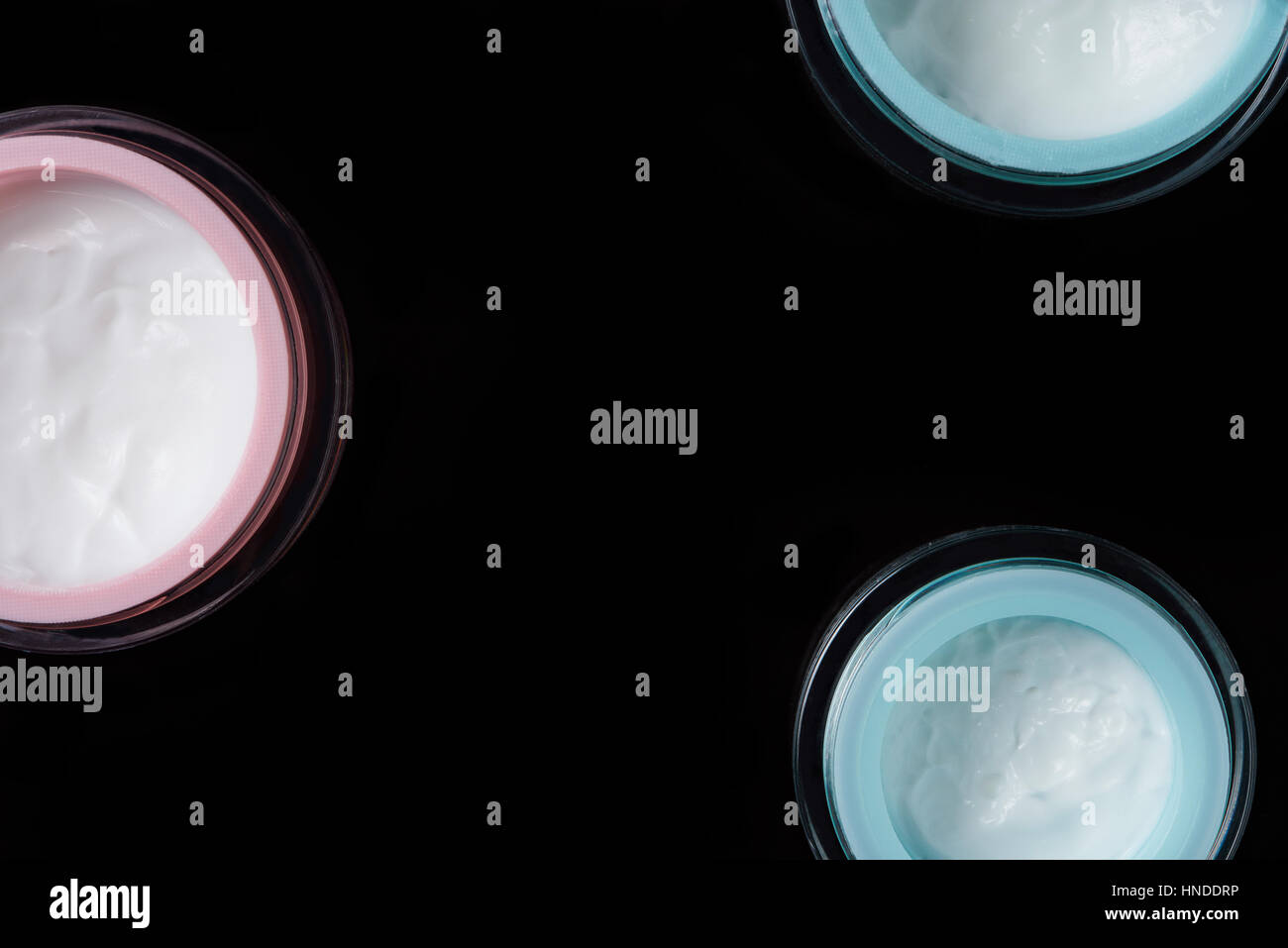 three face cream jars view from top isoalted on black background Stock ...