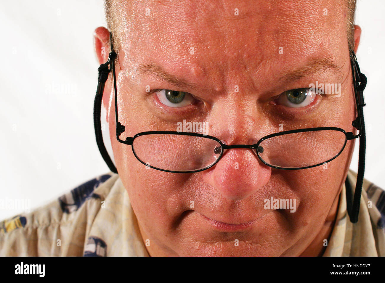 A close up of a middle aged man looking over his glasses Stock Photo ...